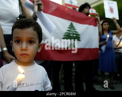 A Lebanese boy holds a candle in downtown Beirut, Lebanon, Thursday ...