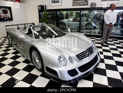 Exotic car dealer Mark Johnston, right, his brother Ernest, rear, and ...