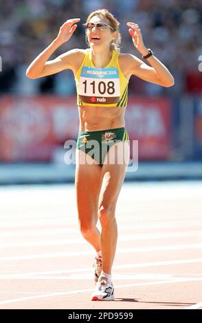 Australia's Kerryn McCann reacts as she crosses the finish line to win ...