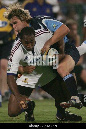 South Africa's Bulls Wynand Olivier, top, tackles Australia's Waratahs ...