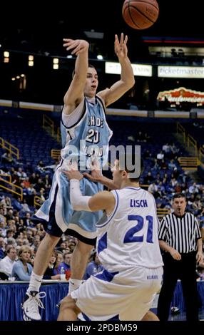 Rhode Island's Jimmy Baron (20) drives to the hoop over Dayton's Kurt ...