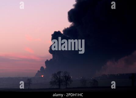 Smoke and flames continue to rise above the Buncefield Oil Terminal in ...