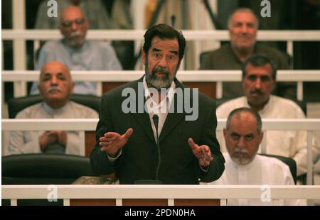 Saddam Hussein speaks to the Presiding Judge Rizgar Mohammed Amin ...