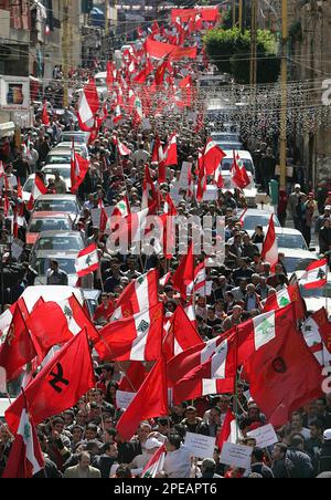 Supporters of the Lebanese Communist party, wave by Lebanese flags ...