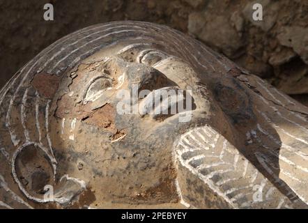 The face of an ancient wooden coffin, shaped like a human body that ...