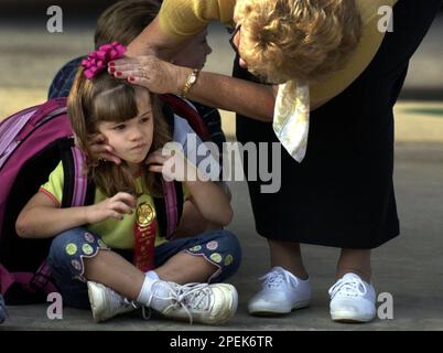 Patterson Elementary School teacher's aide Sue Price, right, examines ...