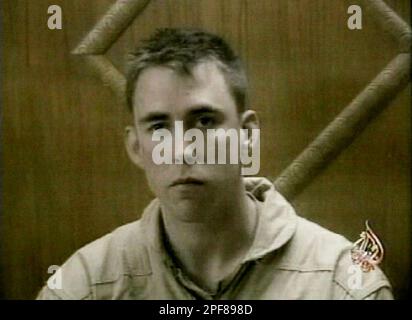 Chief Warrant Officer Ronald D. Young Jr., left, a former POW, listens ...