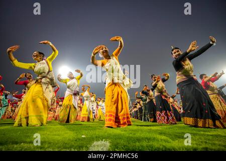 Assamese dancers in traditional attire prepare to perform as they ...