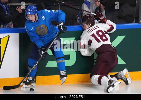 Rodrigo Abols of Latvia, right, fights for a puck with Danil Butenko of ...