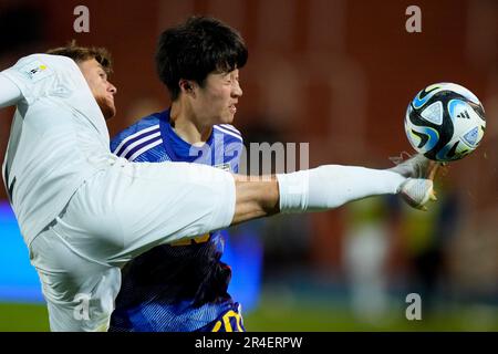 Israel's Ilay Feingold, left, strikes a ball against Japan's Taisei Abe ...