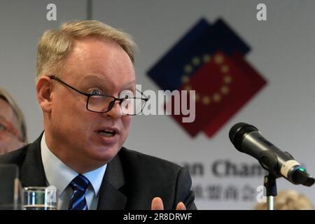Jens Eskelund, President, European Chamber drinks from a cup at the ...