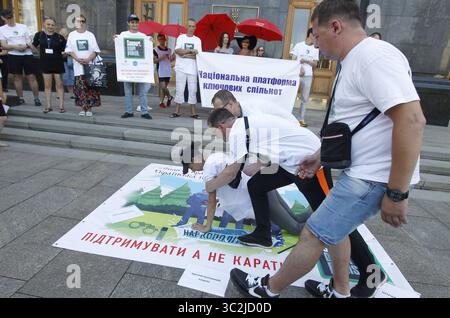 Demonstrators perform as victims in a torture device, called pau-de ...