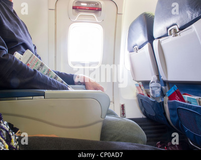 Männlichen Passagier sitzt im Notausgang im Flugzeug Stockfotografie ...