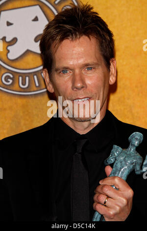 Actor Kevin Bacon of "Taking Chance" signs a guitar at the Gibson ...