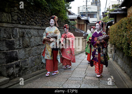 Japanese geishas in a traditional dresses, walk around as visitors look ...