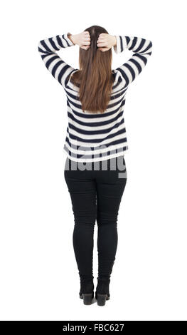 Rückansicht des schockiert Frau in Jeans. Mädchen versteckte seine ...