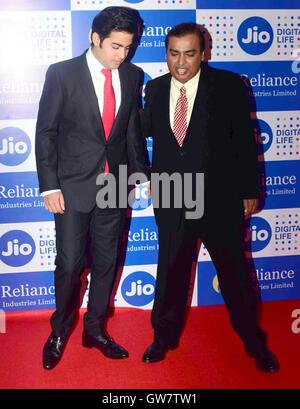 Chairman of Reliance Industries Limited Mukesh Ambani, left, and his son Akash Ambani pose ...