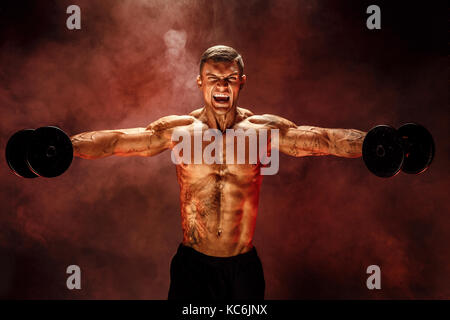sehr bullige Kerl Bodybuilder, Übung mit Hanteln, am Musculus ...