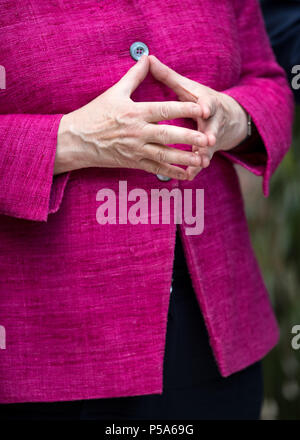German chancellor Angela Merkel (R) bildet Teig am Stand von der ...
