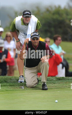 Rocco Mediate and his caddie Matt Achatz, left watch as Tiger Woods ...