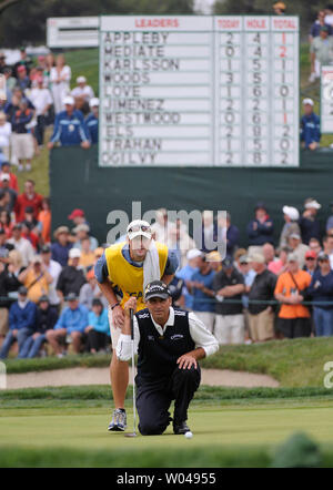Rocco Mediate and his caddie Matt Achatz, left watch as Tiger Woods ...