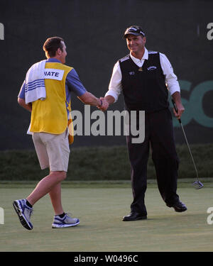 Rocco Mediate and his caddie Matt Achatz, left watch as Tiger Woods ...