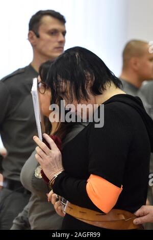 Alena Zsuzsova covers her face as she is escorted in a courtroom ahead ...