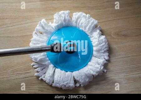 Un balai à franges rond avec tête en microfibre sur sol en carreaux de ...