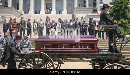 An honor guard and horse drawn caisson transports the casket carrying ...