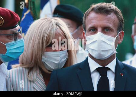 France's President Emmanuel Macron wearing a flower lei and seashell ...