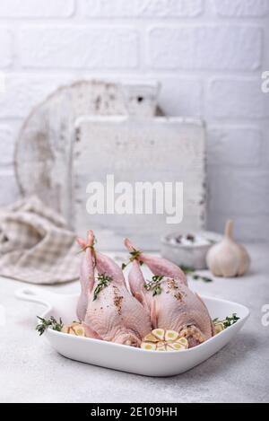 Viande de caille crue aux épices, à l'ail et aux herbes Photo Stock - Alamy