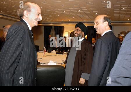 Hezbollah leader Sheik Hasan Nasrallah, left, shakes hands with the ...
