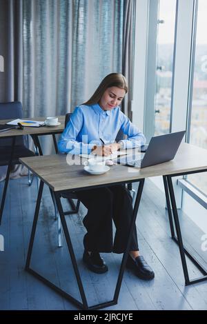 Le secrétaire vérifie le calendrier. Gaie jeune belle femme en lunettes ...