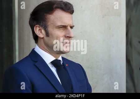 France's President Emmanuel Macron wearing a flower lei and seashell ...