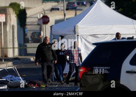 Police investigators and members of the Los Angeles County Department ...