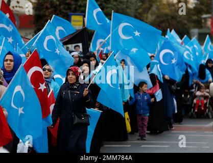 People from the Uighur community living in Turkey carrying flags of ...