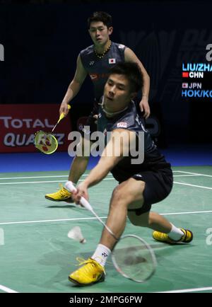 Japan's Yugo Kobayashi, with Takuro Hoki, returns a shot against Taiwan ...