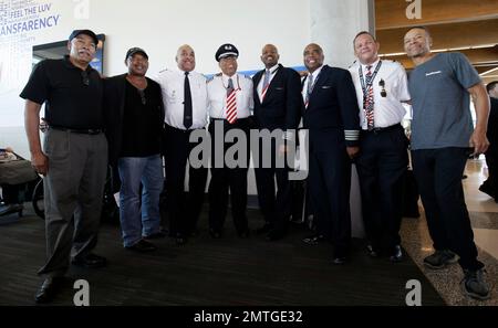 Southwest Airlines captain Louis Freeman talks on a cell phone as he ...