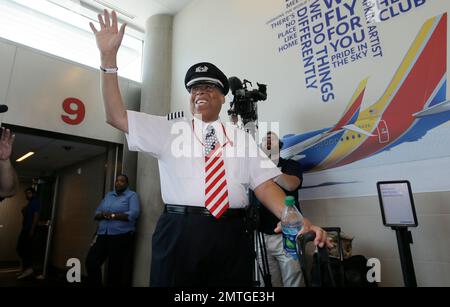 Southwest Airlines captain Louis Freeman talks on a cell phone as he ...