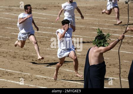 Barefoot runners wearing tunics take part in a footrace in the ancient ...