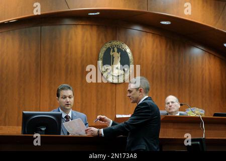 Alexandria police officer William Oakley, holds up evidence on the ...