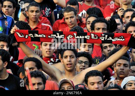 An Egyptian club Al Ahly fan plays the trumpet during the African ...