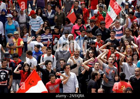 Supporters of the Lebanese Communist party, wave by Lebanese flags ...