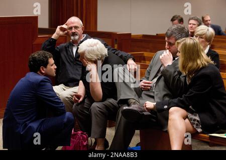 Glenda Watson, second from left, is hugged by her husband David Watson ...
