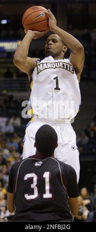 Marquette's Dominic James (1) shoots over Villanova's Corey Fisher (10 ...