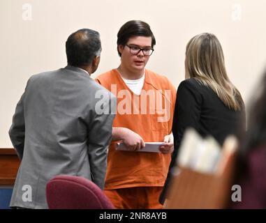 Jacob Kaderli, left, and Michael Helterbrand, right, sit with ...