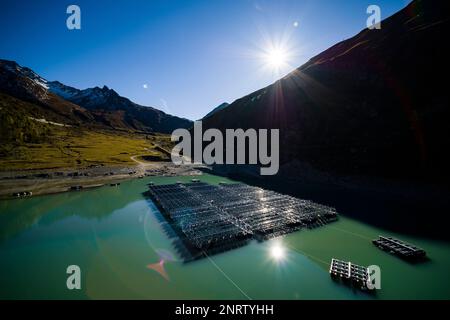 Floating barges with solar panels are pictured on the 'Lac des Toules ...