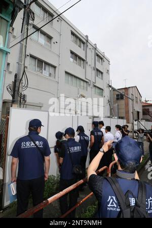 Police officers enter Aleph, the group whose name was changed from Aum ...