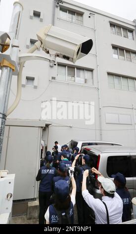Police officers enter Aleph, the group whose name was changed from Aum ...