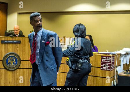 Flint City Councilman Eric Mays is handcuffed as he is detained during ...